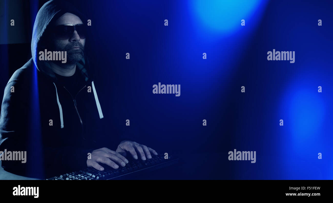 Computer hacker typing on keyboard Stock Photo - Alamy