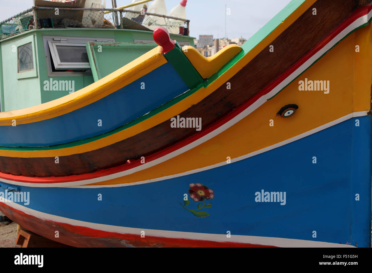 A traditional Maltese fishing boat, the Luzzu hauled up and being ...