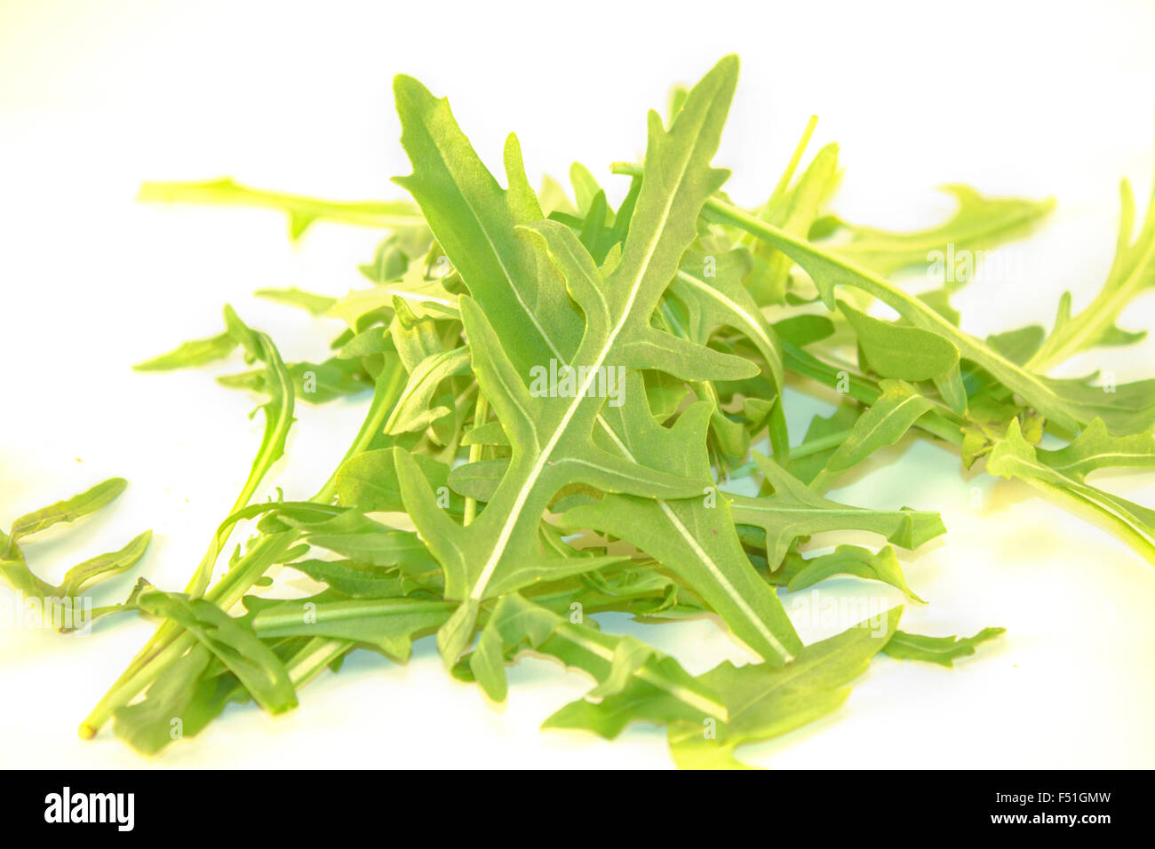 A pile of green rucola, isolated on white background Stock Photo - Alamy