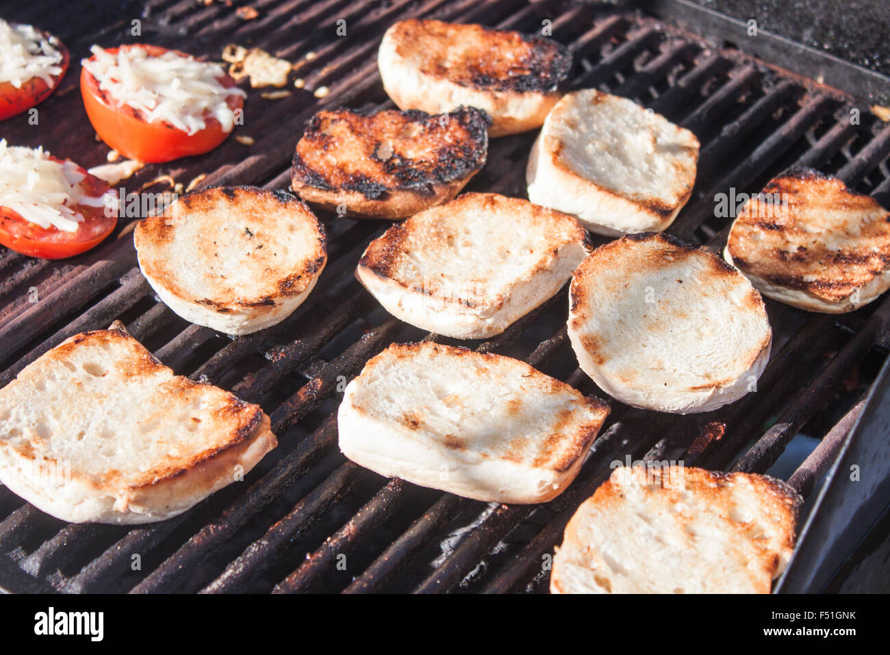 A barbeque full of tomatoes and grilled bread Stock Photo - Alamy
