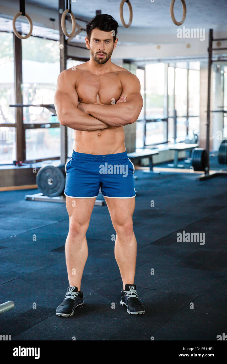 Athletic man wearing blue shorts standing with arms crossed Stock Photo ...