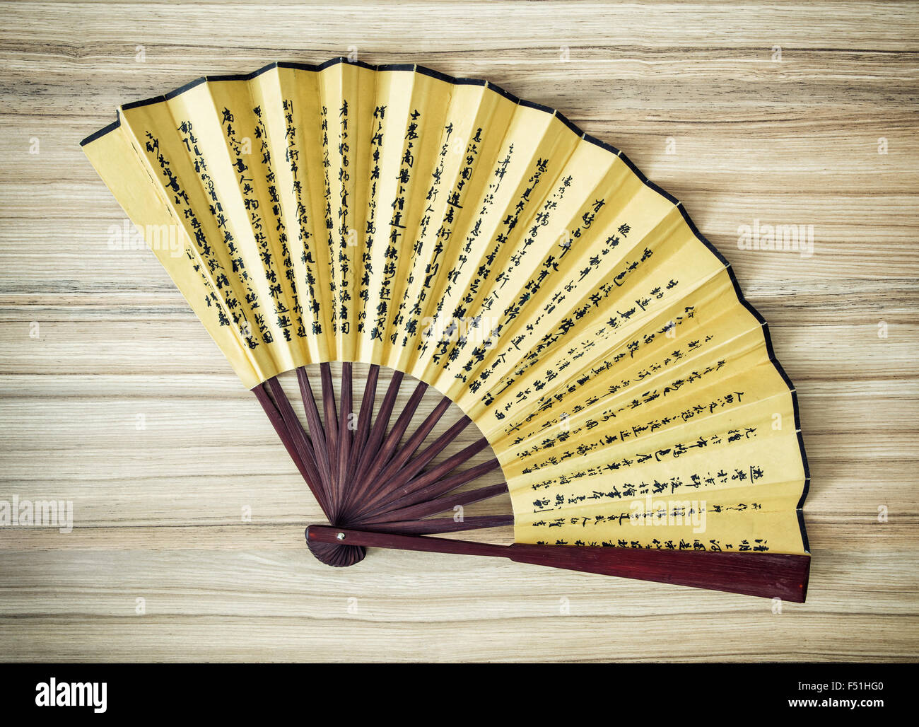 Traditional eastern fan on the wooden background. Fashion accessory ...