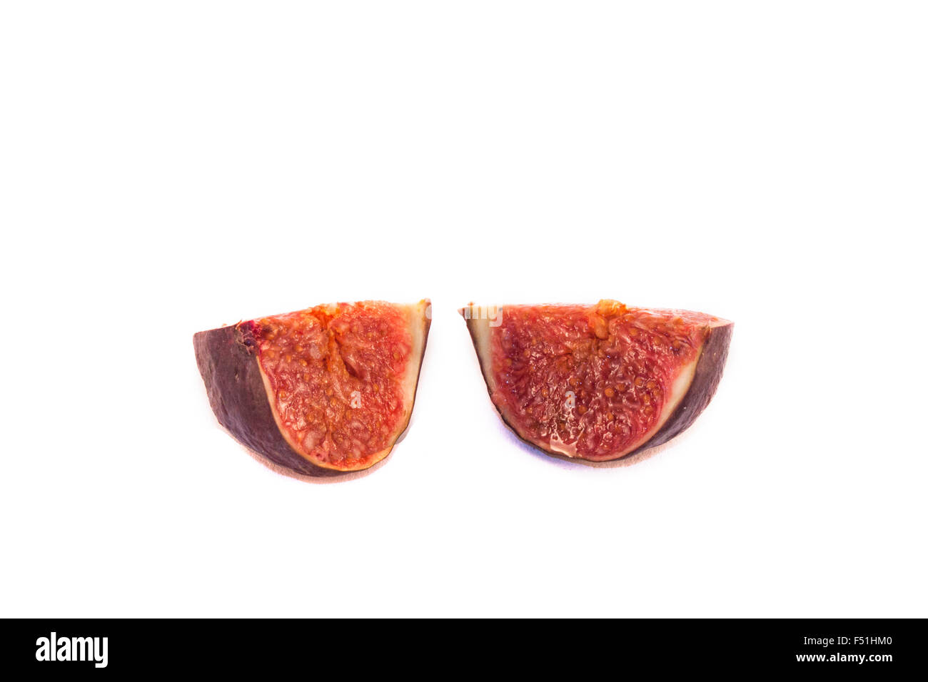 Two isolated, purple figs, on white background Stock Photo - Alamy