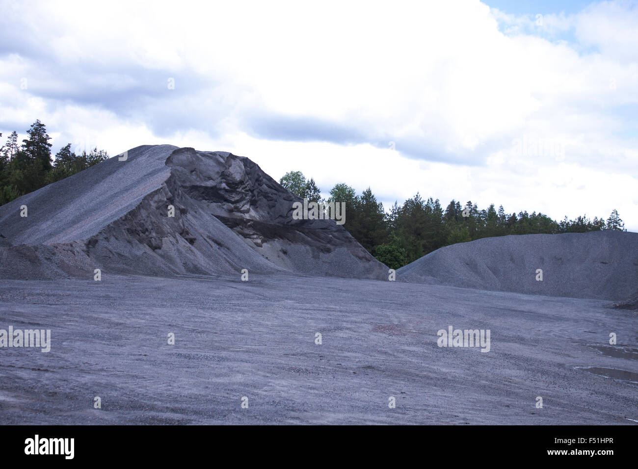 Piles of grey stone, at a stone mine Stock Photo - Alamy