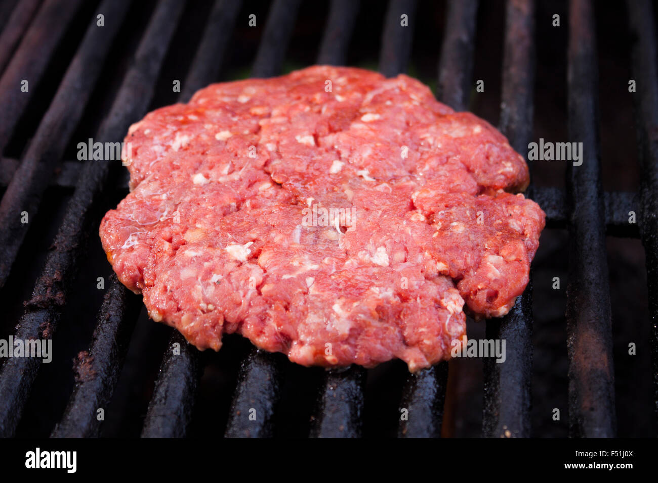 Grilling a Raw hamburger beef, on a barbeque Stock Photo - Alamy