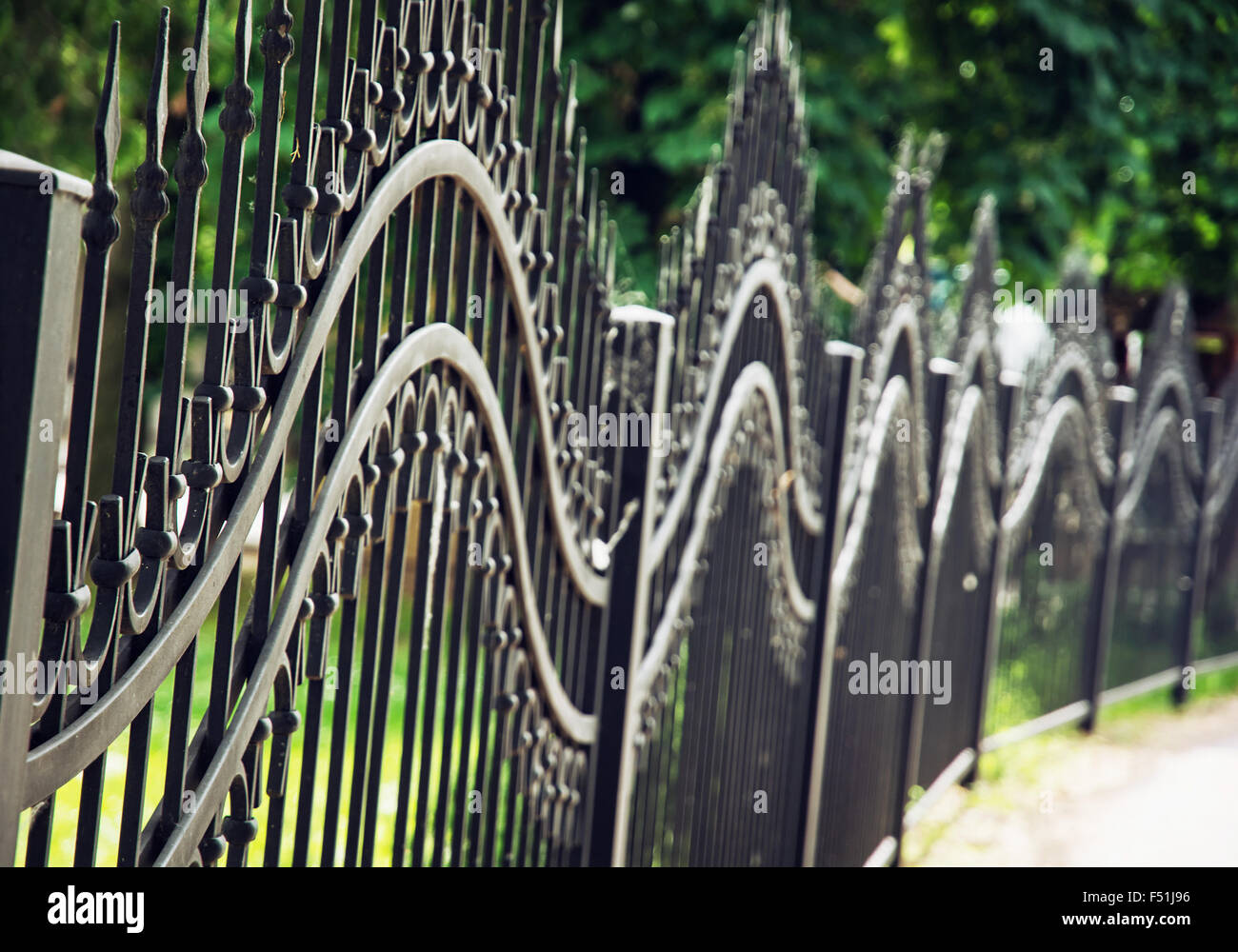 Forged iron fence in the city park. Artistic object Stock Photo - Alamy