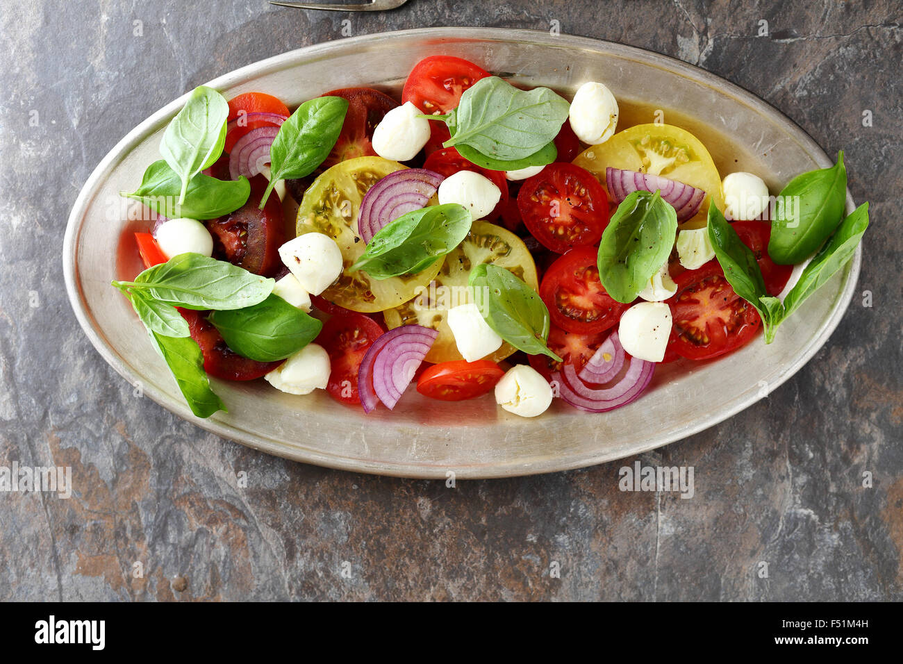 mix tomatoes salad with cheese and basil, food Stock Photo - Alamy
