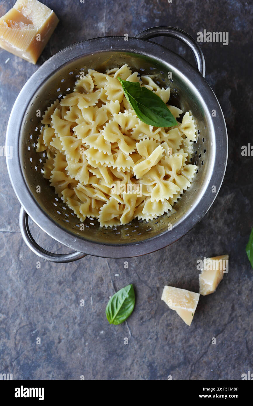 pasta in colander and cheese, food top view Stock Photo - Alamy