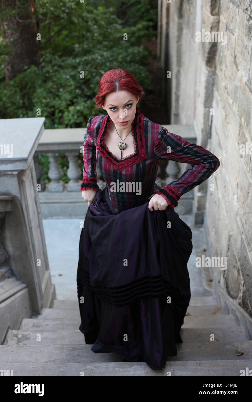 portrait of a beautiful red haired girl wearing Gothic inspired ...