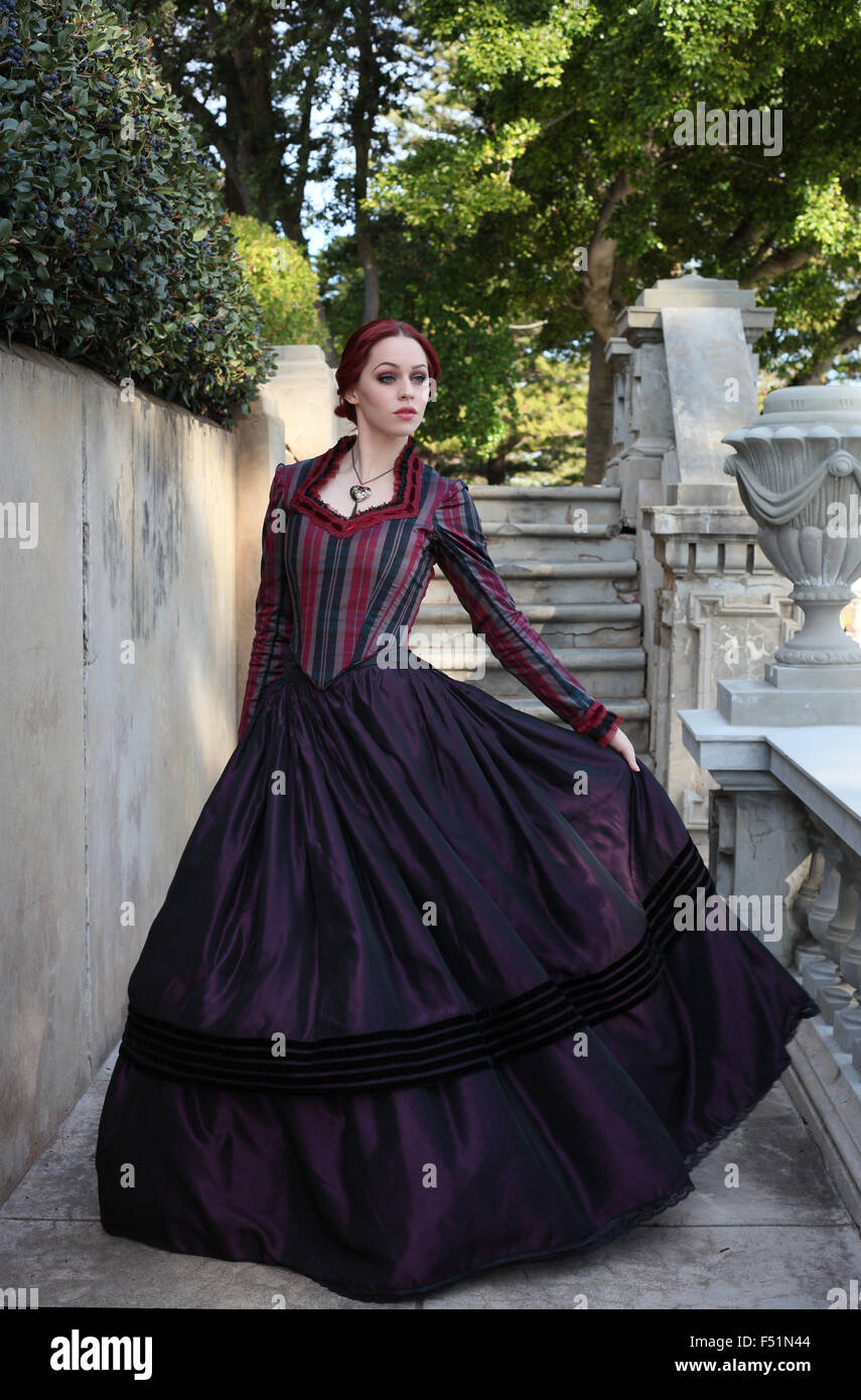 portrait of a beautiful red haired girl wearing Gothic inspired ...