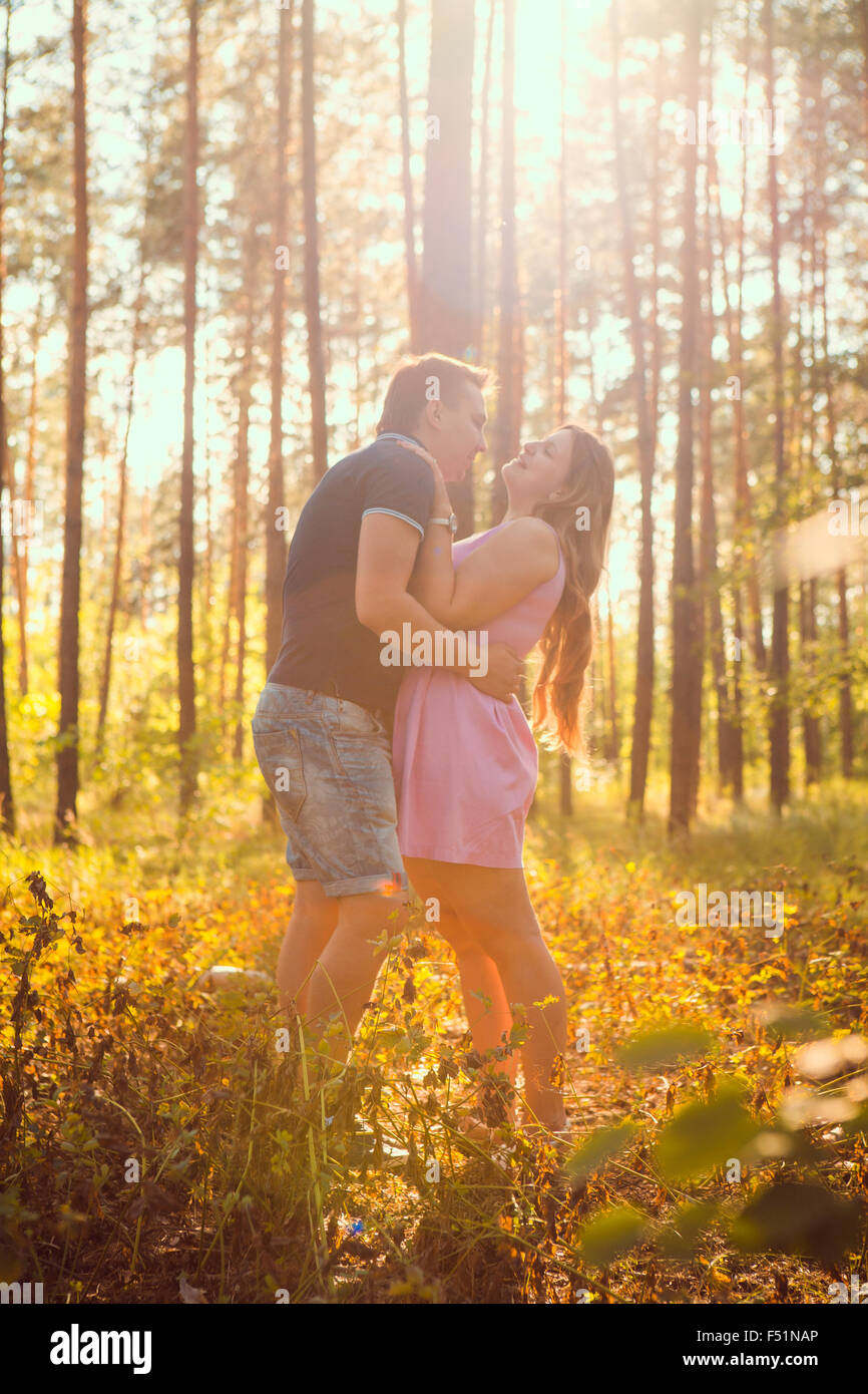 Romantic young couple laugh on background summer forest Stock Photo - Alamy