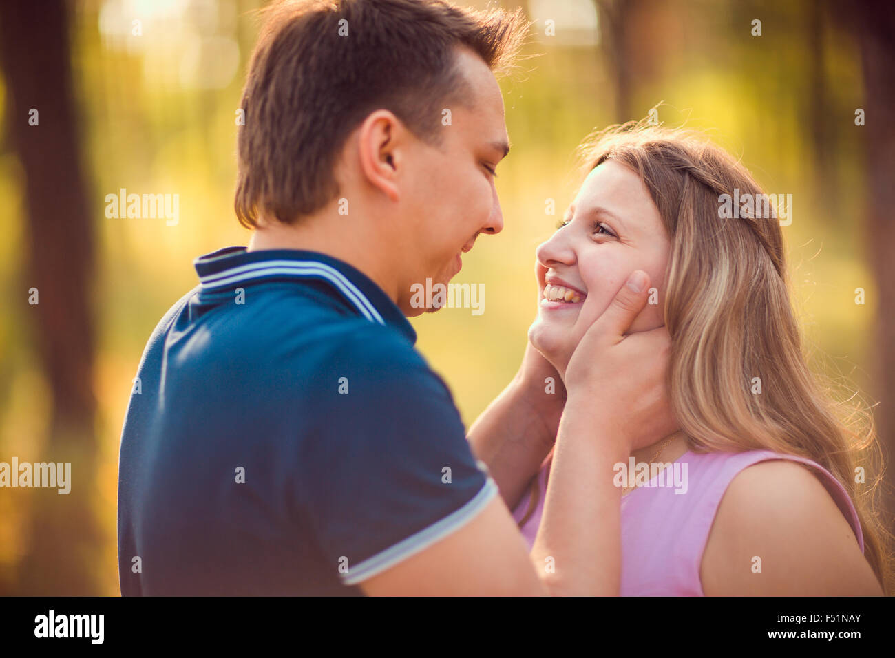 Romantic young couple laugh on background summer forest Stock Photo - Alamy