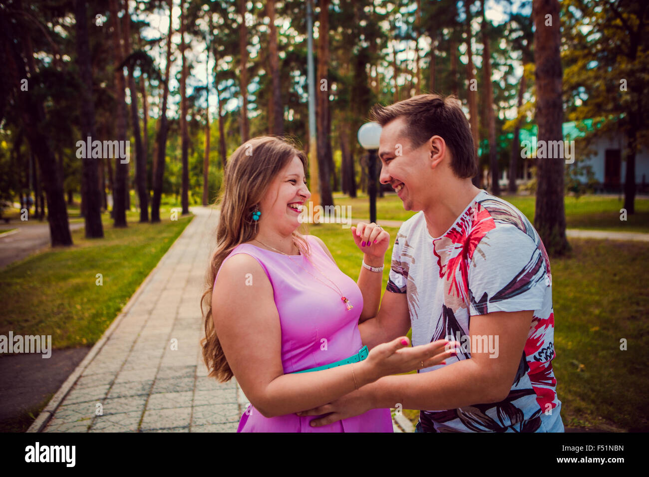 Romantic young couple laugh on background summer forest Stock Photo - Alamy