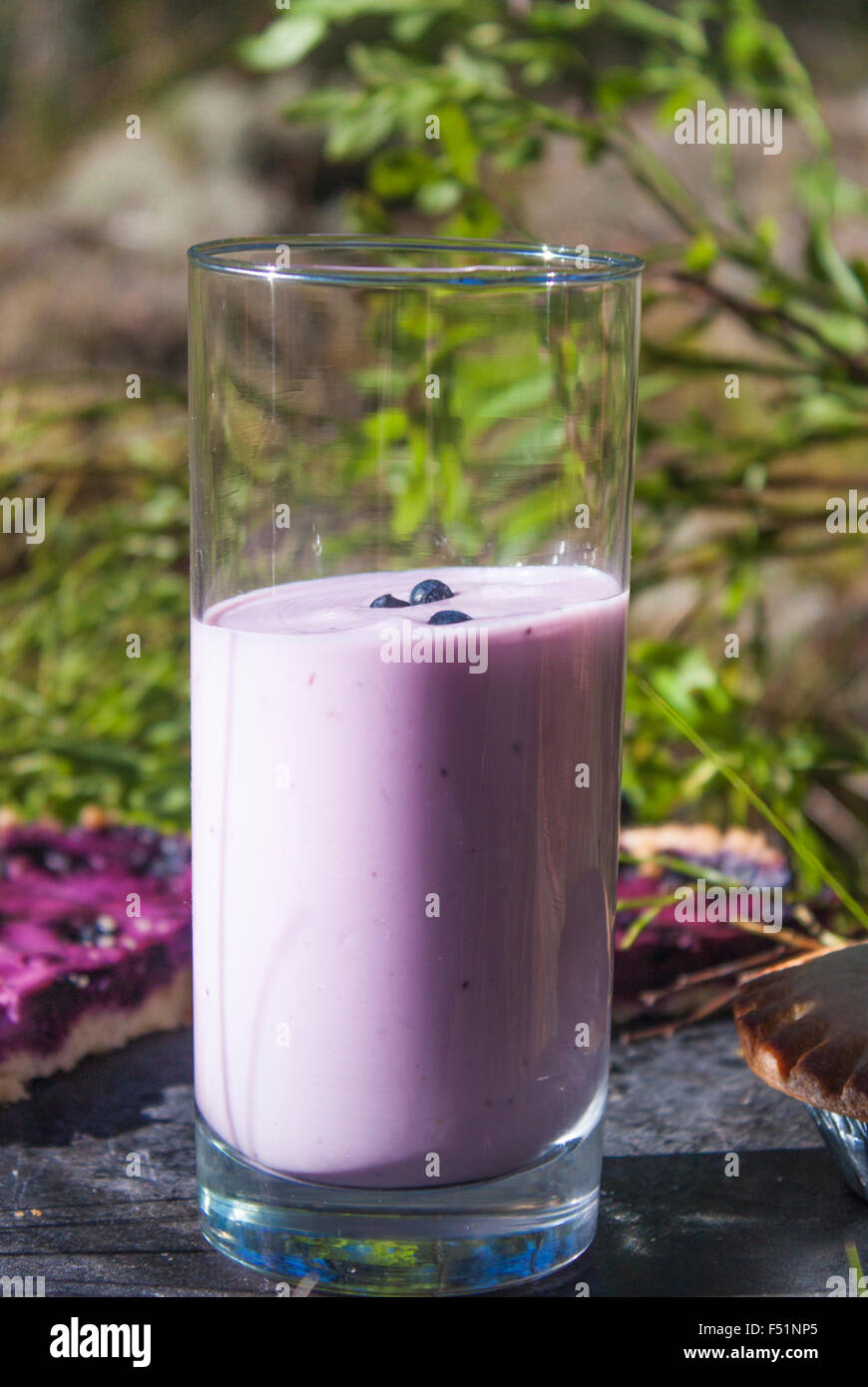 Purple blueberry yoghurt, at a picknick table Stock Photo - Alamy
