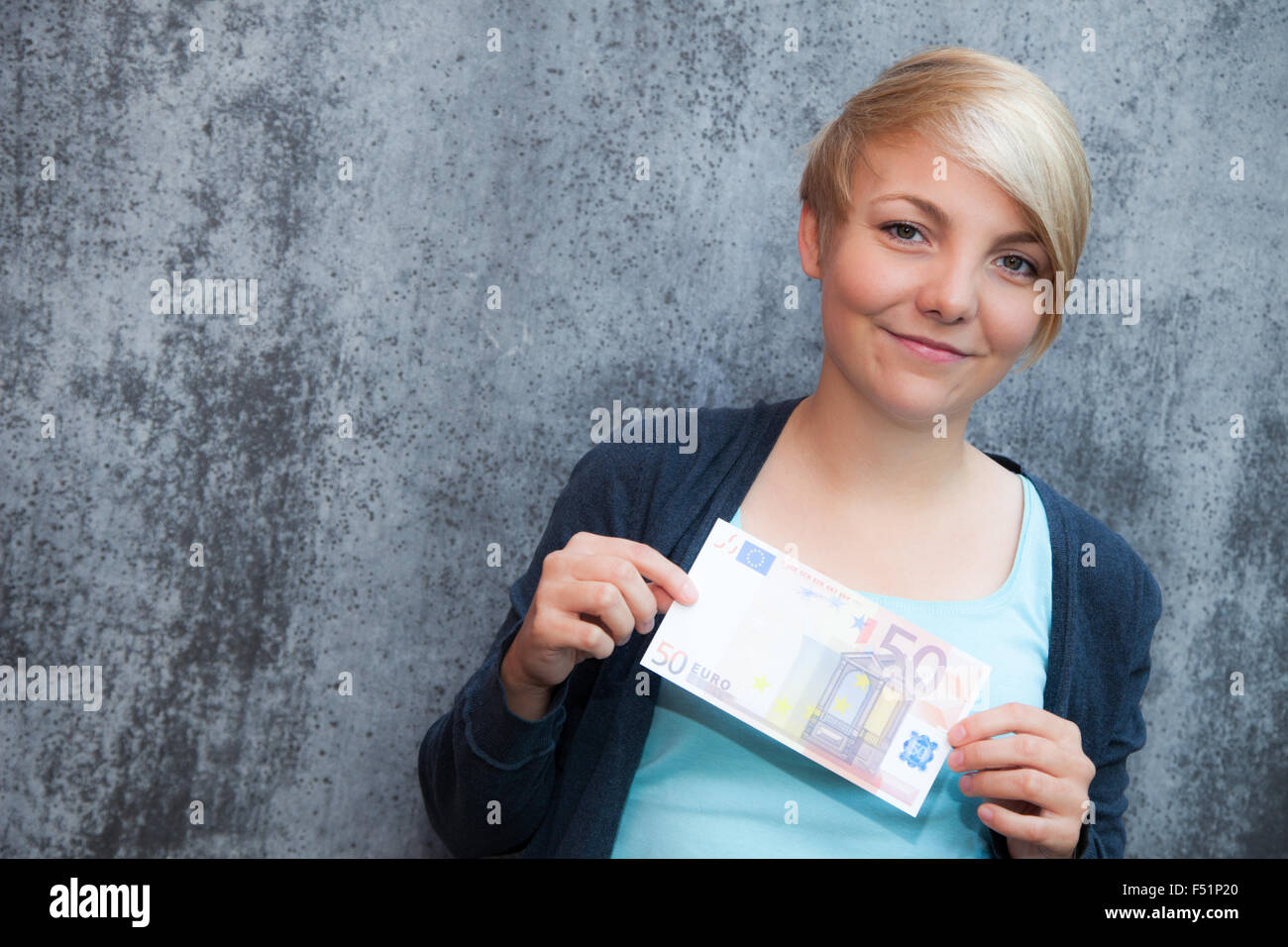 Attractive teenage girl holding fifty euro note Stock Photo - Alamy