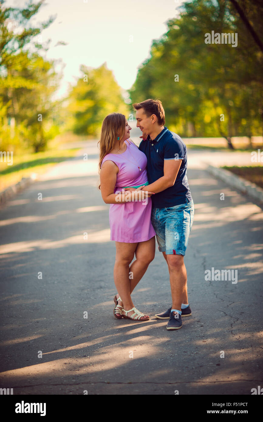 Romantic young couple laugh on background summer forest Stock Photo - Alamy
