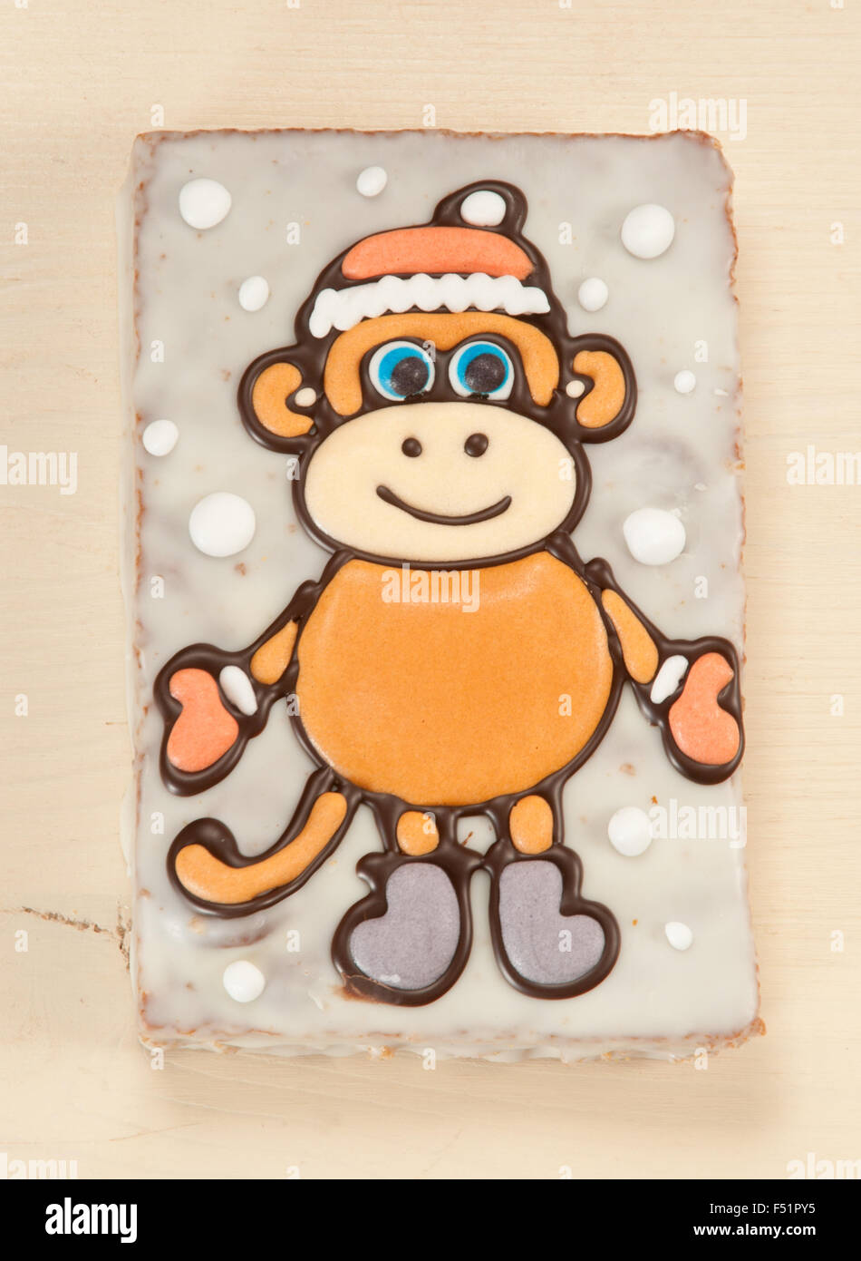 Gingerbread with monkey on a timber background Stock Photo - Alamy