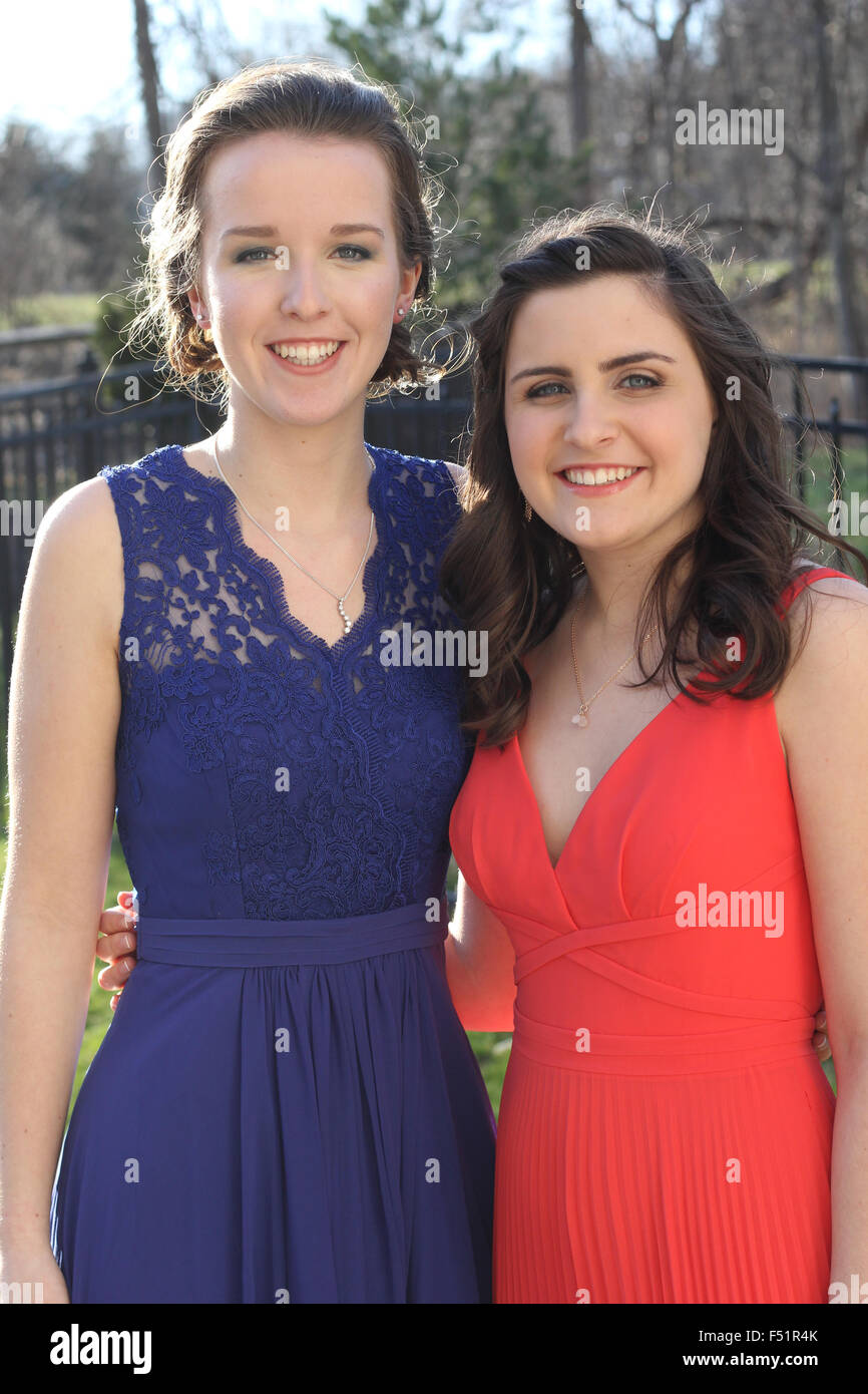 Two girls smiling and wearing prom dresses Stock Photo - Alamy