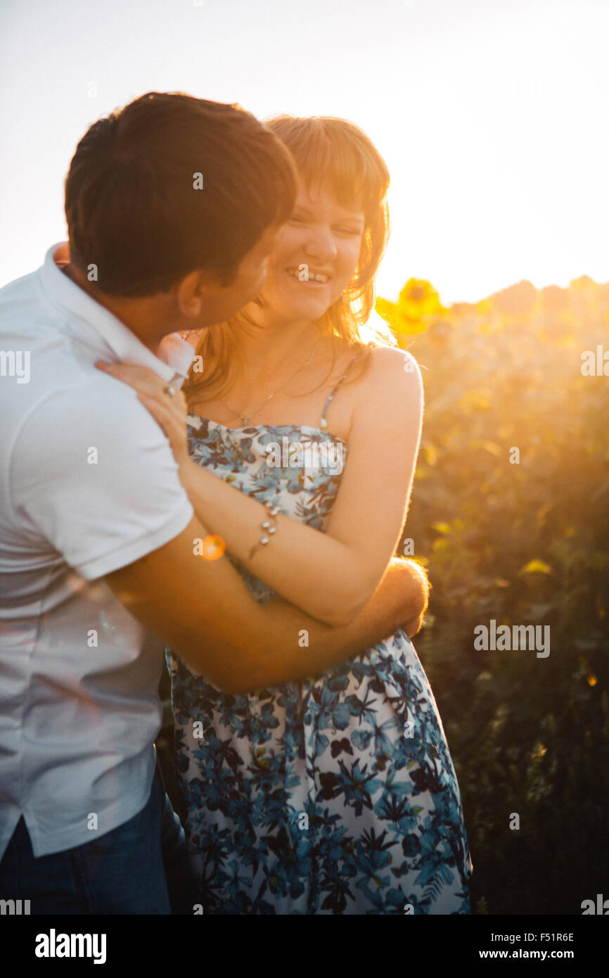 Romantic couple standing and kissing on background summer meadow ...