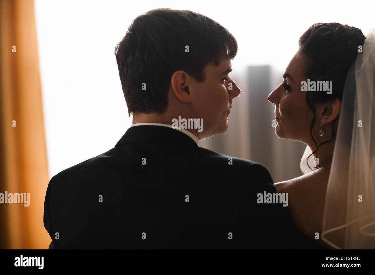 beautiful young couple standing near the window Stock Photo - Alamy