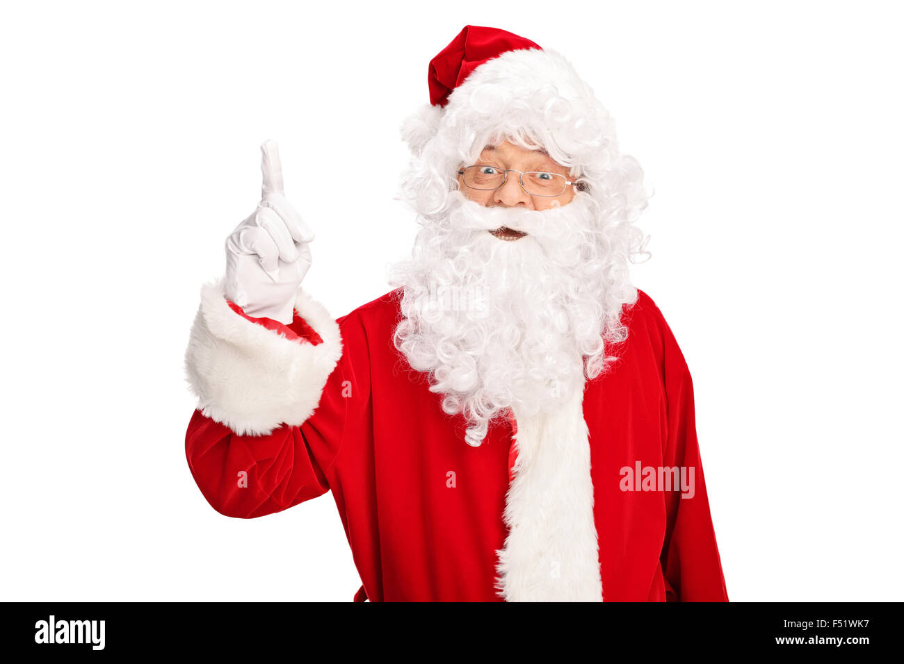 Santa Claus looking at the camera and pointing up with his finger ...
