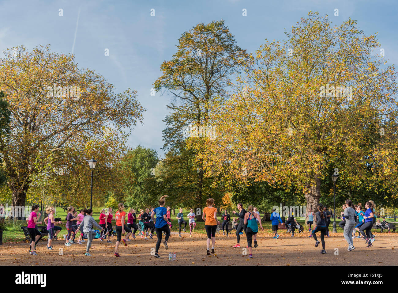 London, UK. 25th October, 2015. An exercise class - Sunny crisp weather ...