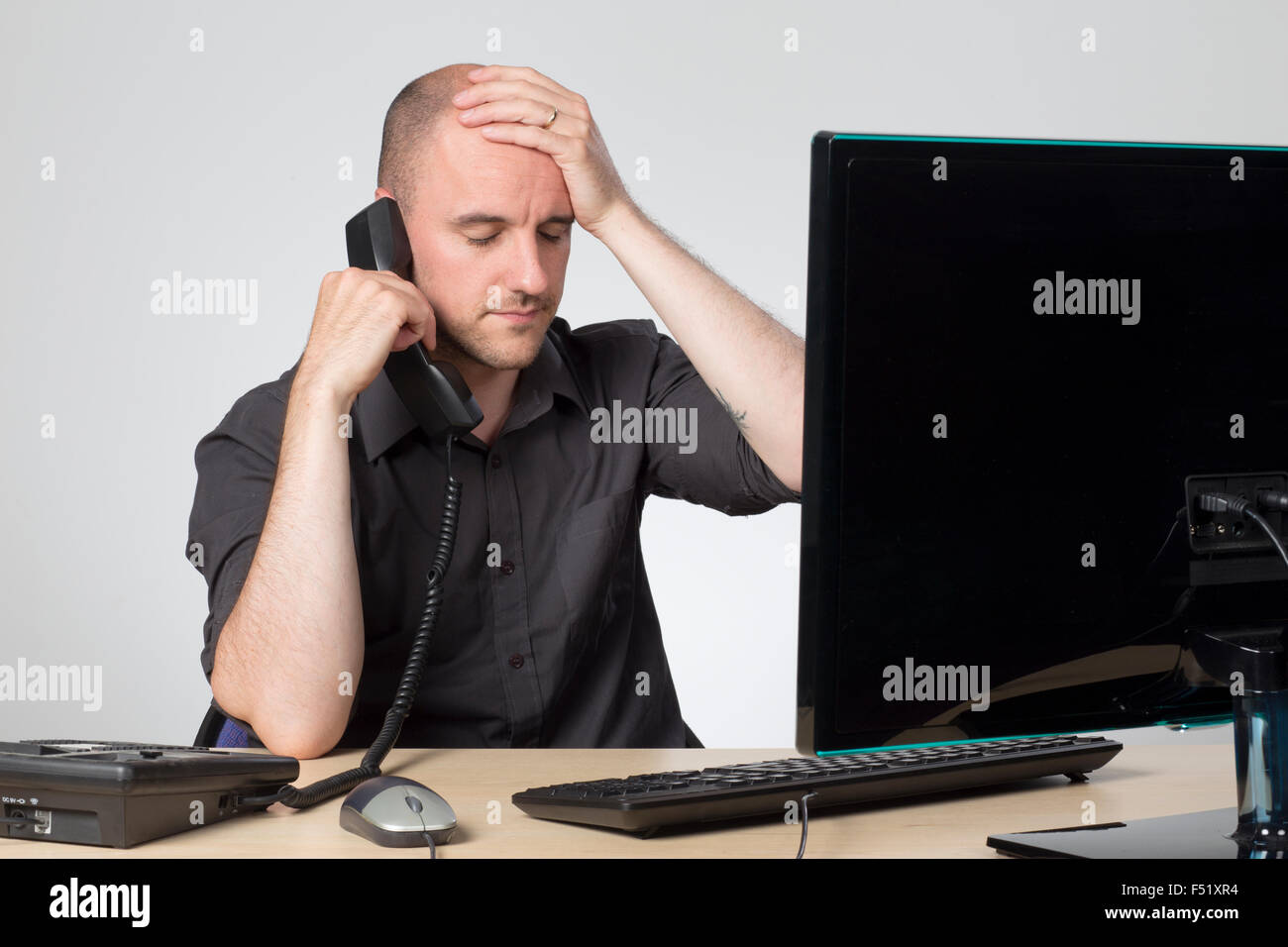 Trying to help over the phone Stock Photo - Alamy