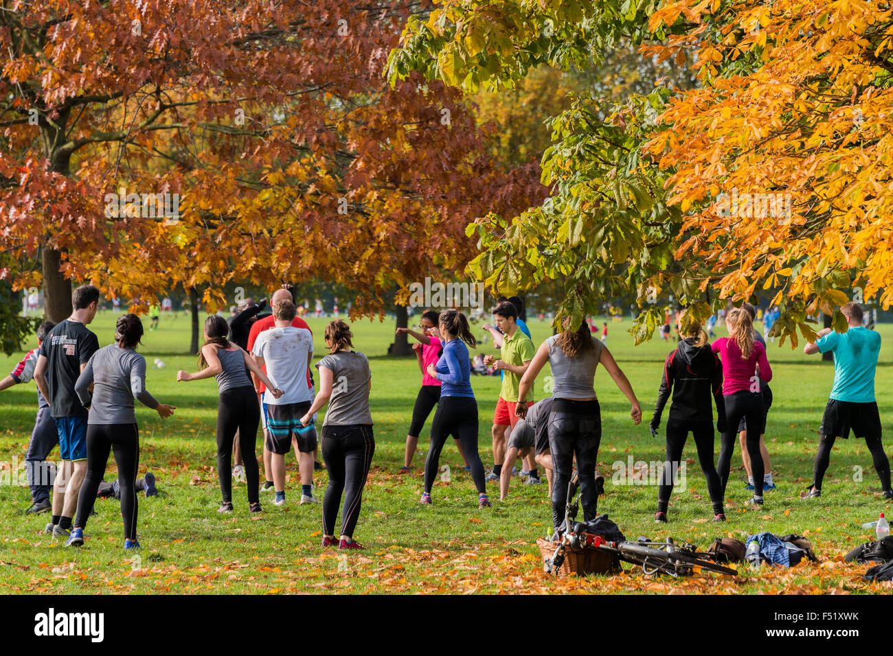 London, UK. 25th October, 2015. An exercise class - Sunny crisp weather ...