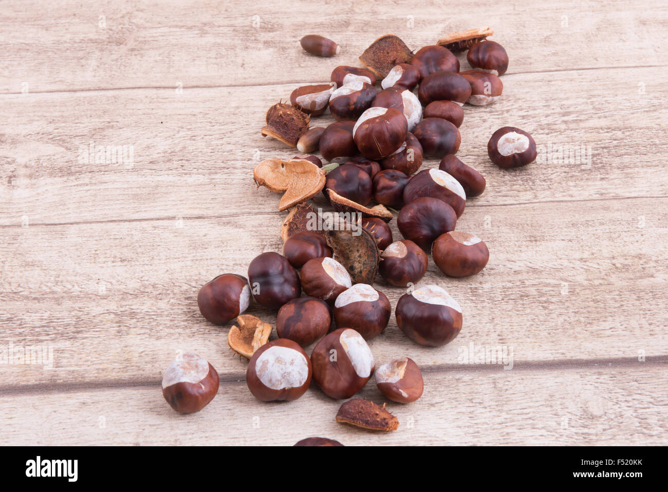 chestnuts and acorns on wooden background with space for own text Stock ...