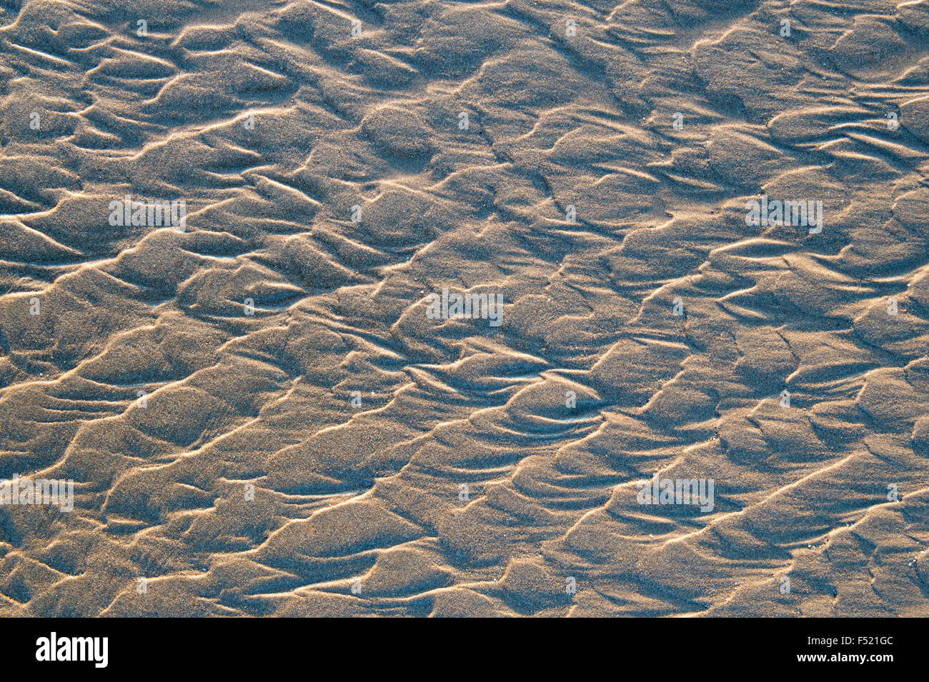 Water patterns on sand with shadows and morning light Stock Photo - Alamy