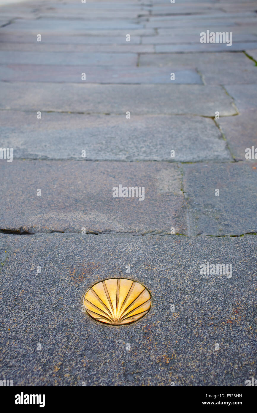 Santiago de Compostela end of Saint James Way golden shell sign on soil ...