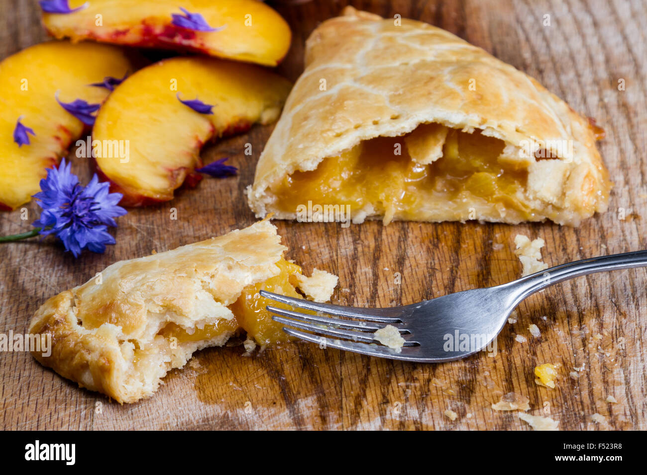 home made peach turnover served on a wooden serving tray with fresh ...
