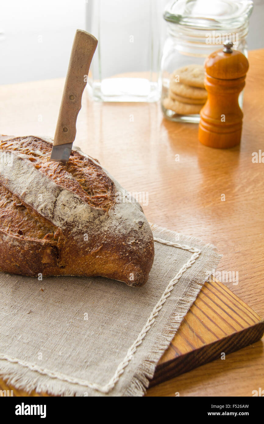 Fresh Tradition bread loaf on the table with kitchen knife,cutting ...