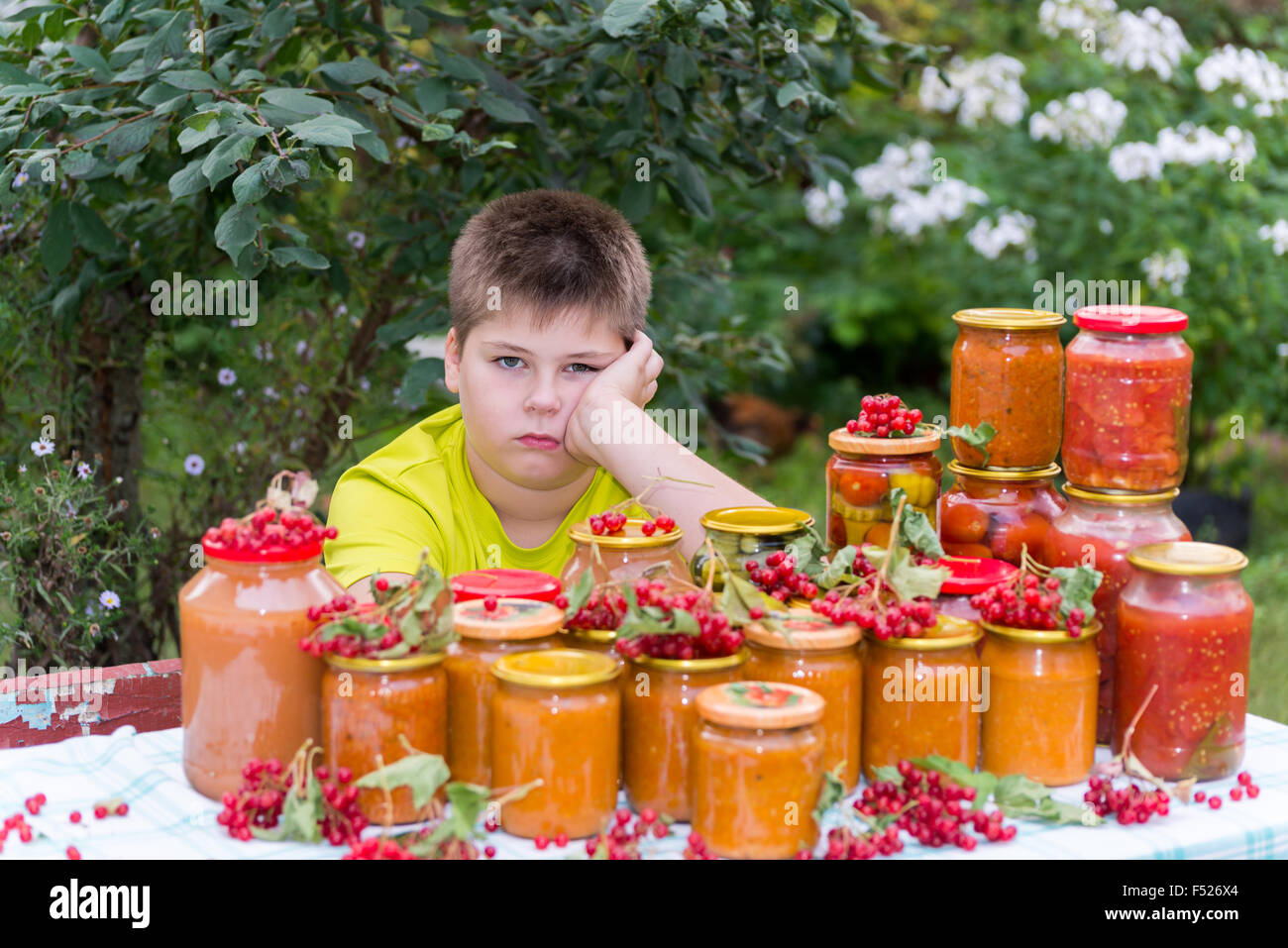 boy and home canned vegetables in nature Stock Photo - Alamy