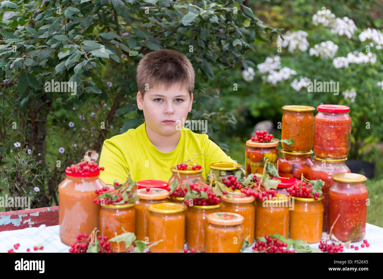 boy and home canned vegetables in nature Stock Photo - Alamy