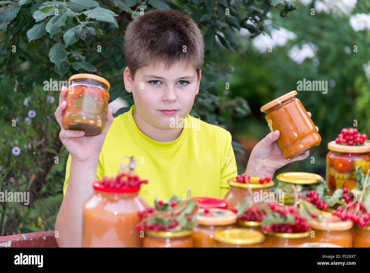 boy and home canned vegetables in nature Stock Photo - Alamy