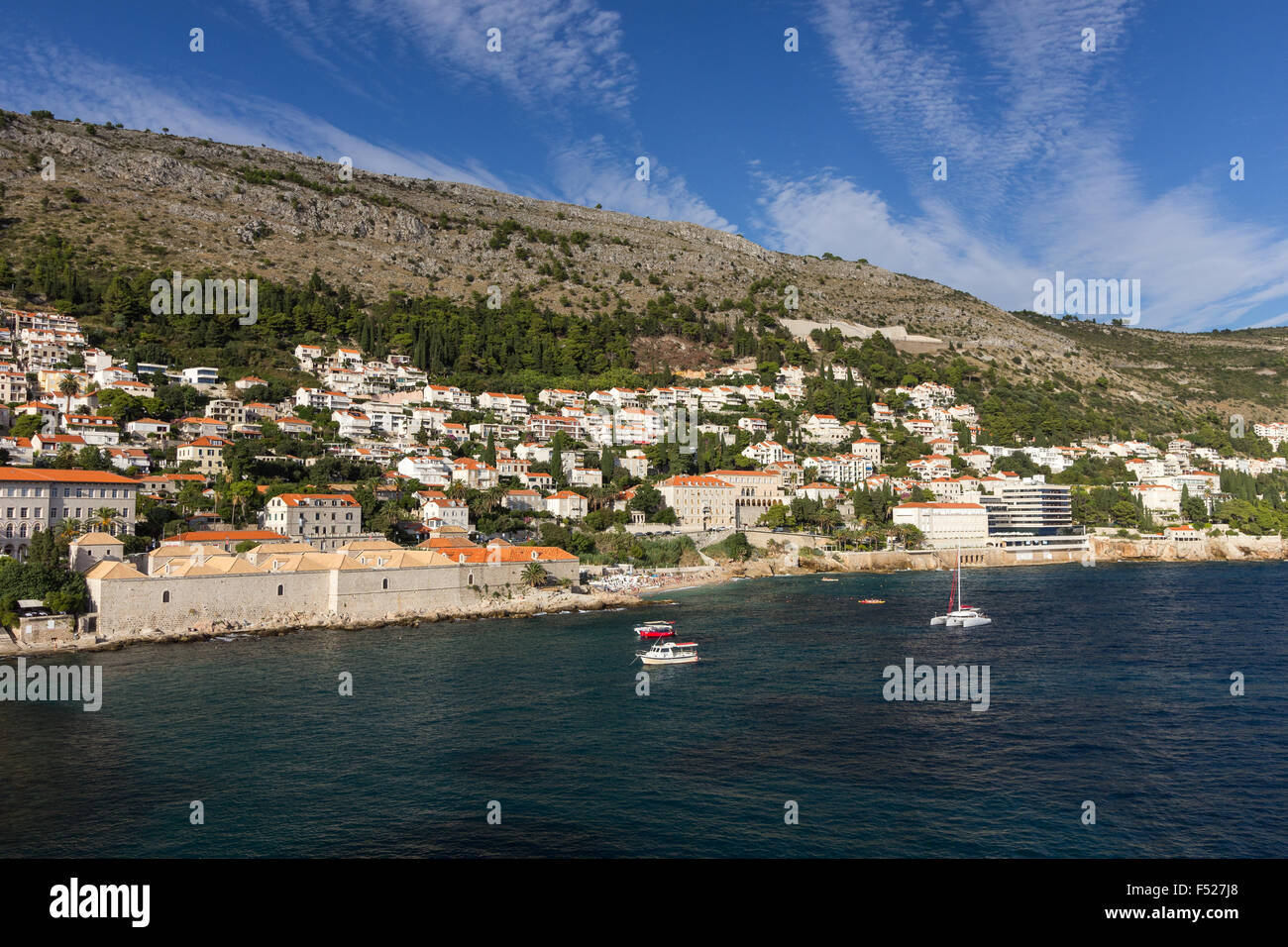 View of buildings on the hillside and Mount Srd from the sea in ...