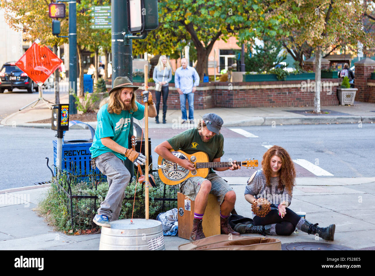 Street musicians busk in front of Pritchard Park in Asheville, North ...