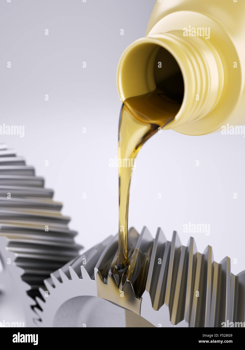 Oiling gears on grey background Stock Photo - Alamy