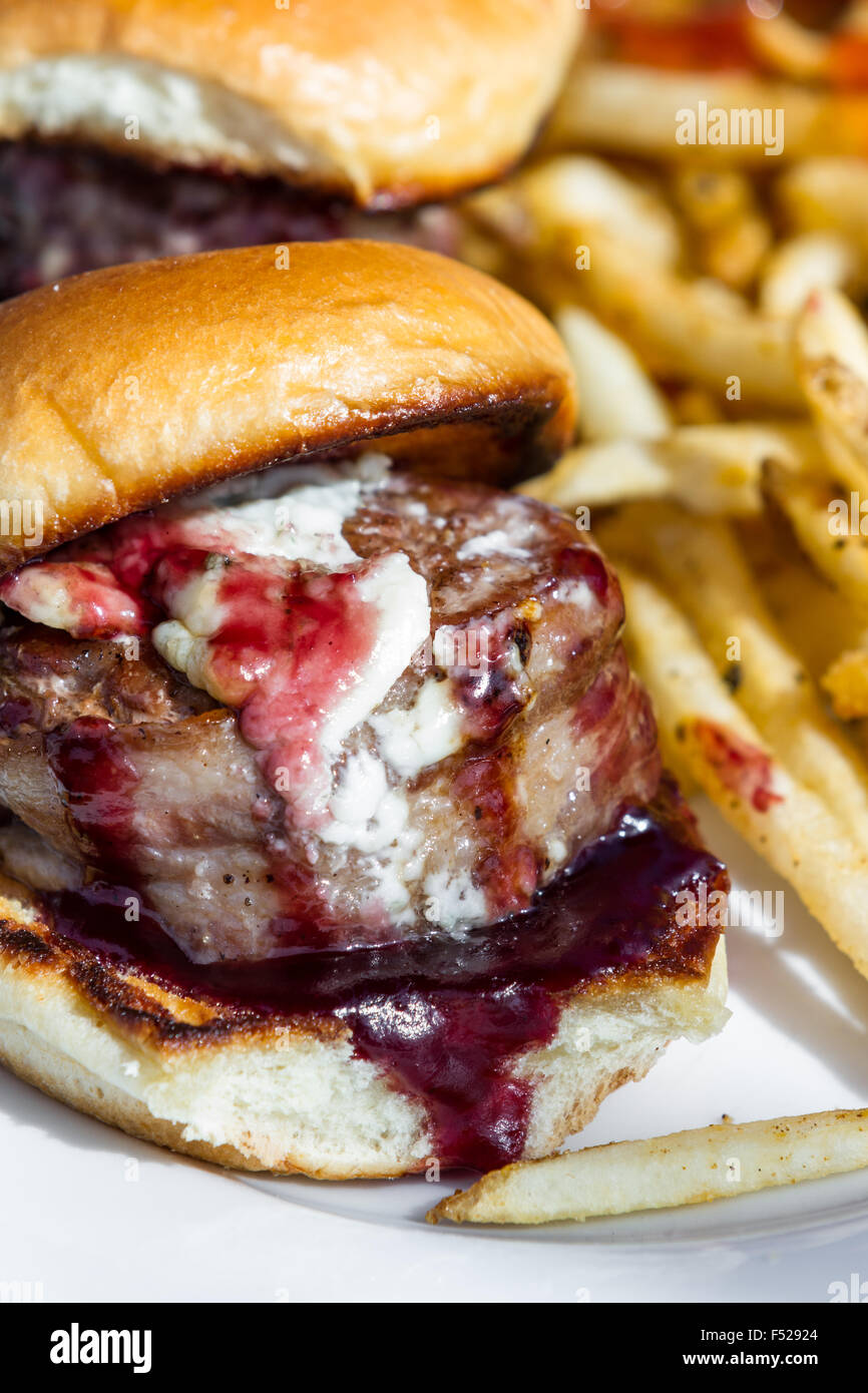serving of two tenderloin sliders with seasoned shoe string fries Stock ...