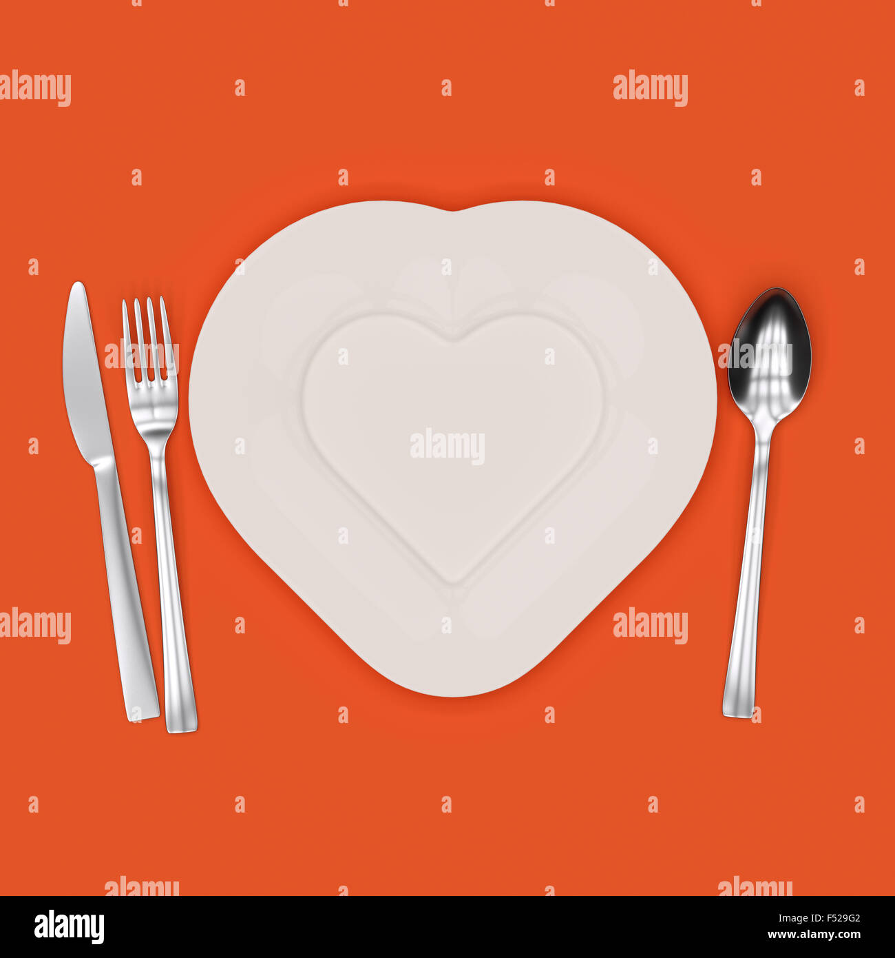 Heart-shaped plate with fork, knife and spoon Stock Photo - Alamy
