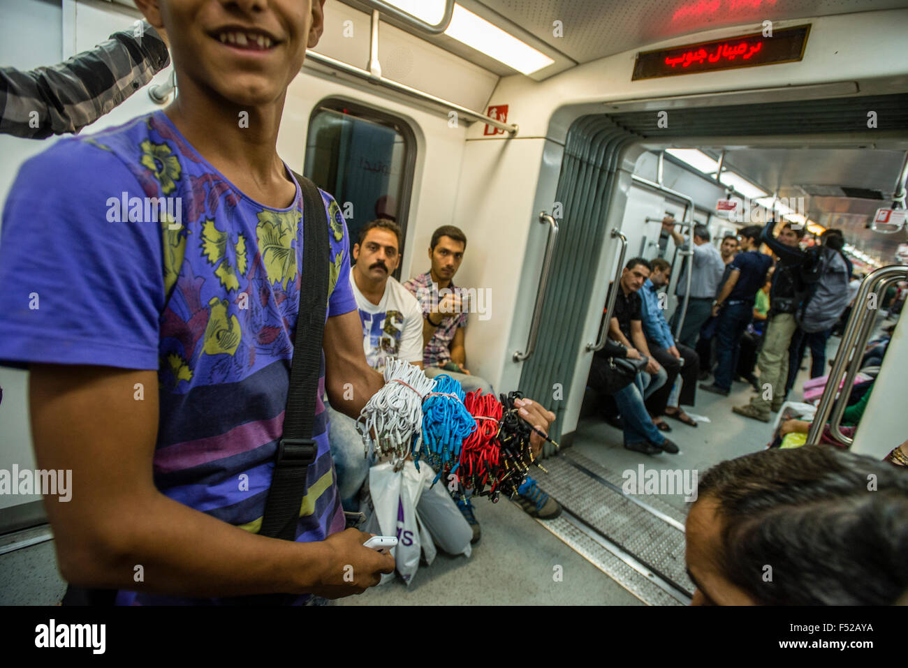 A boy sells goods aboard a train in Tehran subway, Iran Stock Photo - Alamy