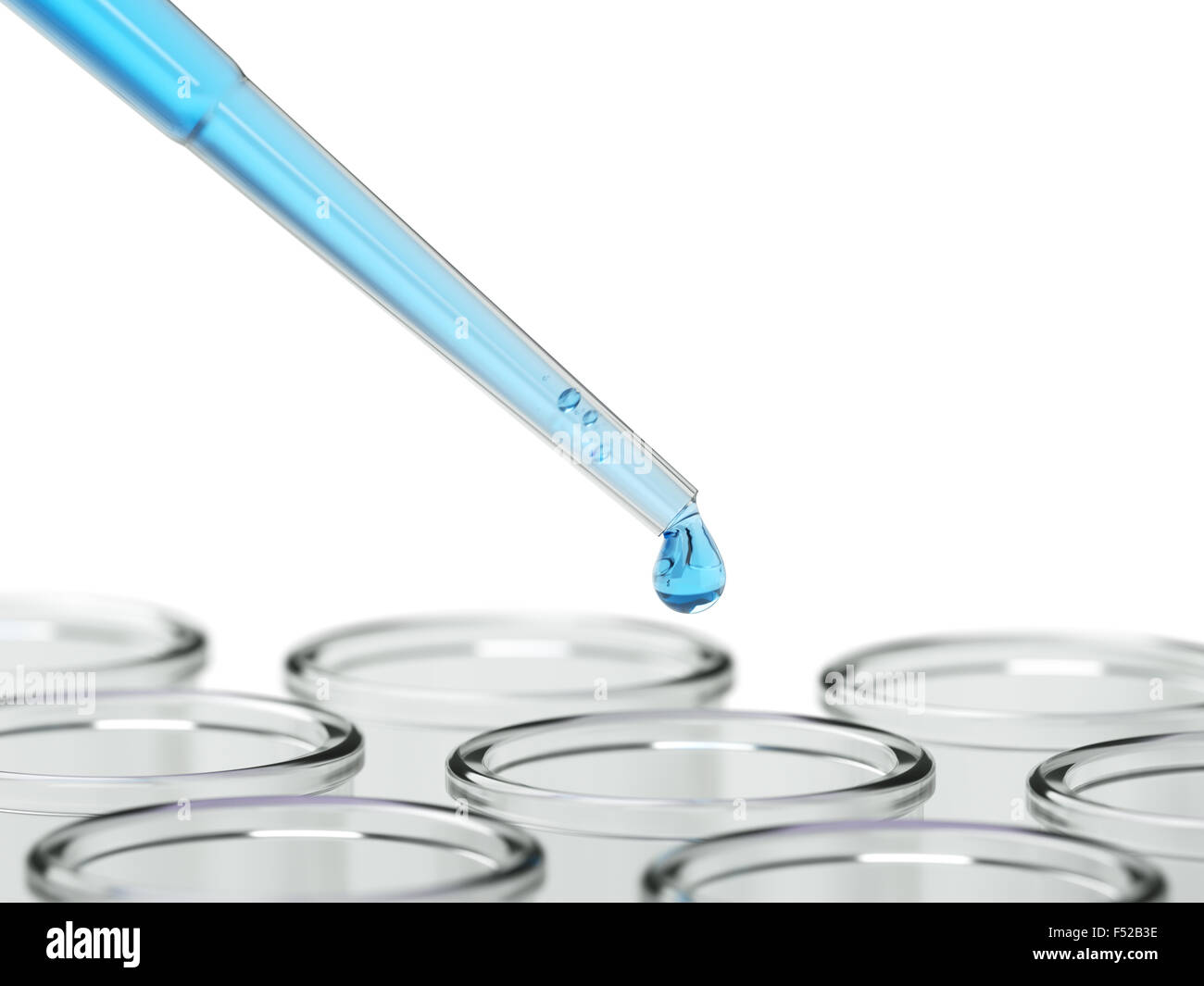 Dropping blue liquid in test-tubes isolated on white Stock Photo - Alamy