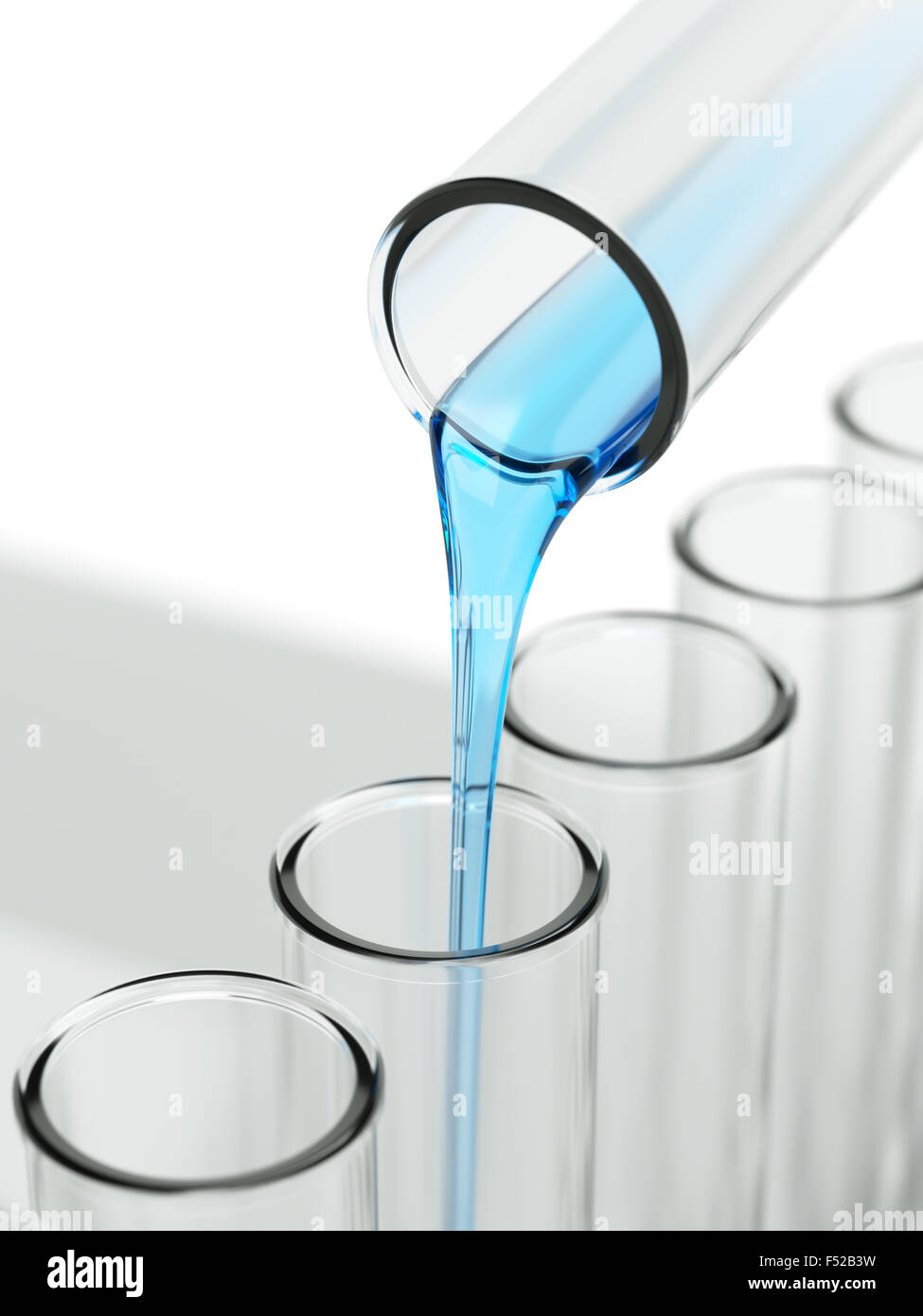 Pouring liquid in laboratory glassware on white background Stock Photo ...