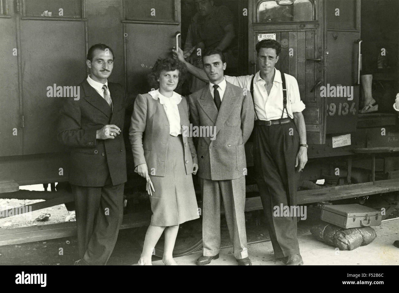 Passengers and train departing , Italy Stock Photo - Alamy