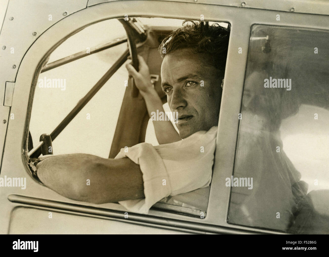 Pilot leaning out a window of an airplane, Italy Stock Photo - Alamy