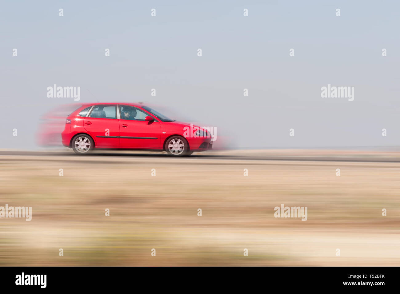 Fast moving red car Stock Photo - Alamy