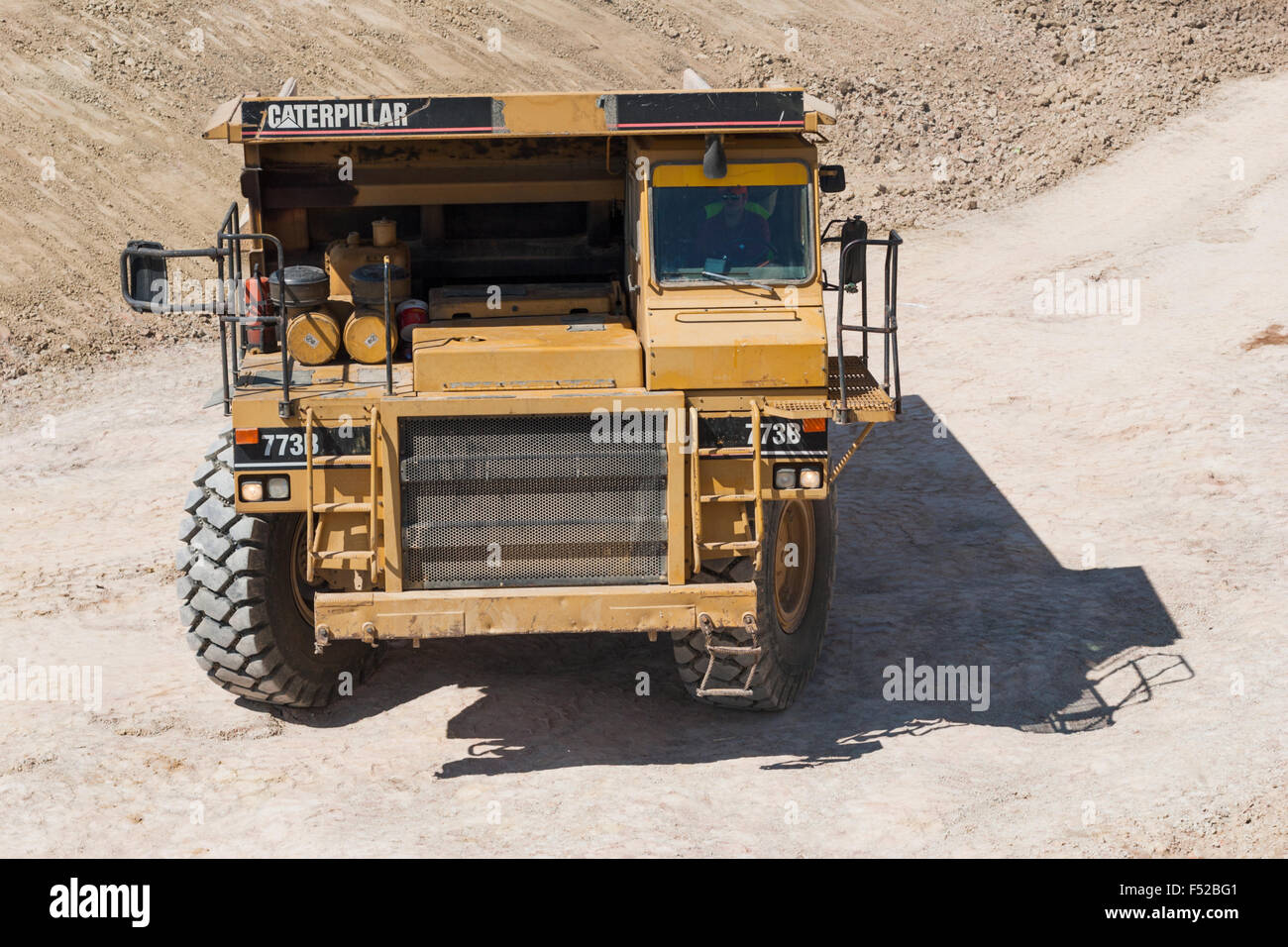 Yellow mining truck at work site Stock Photo - Alamy