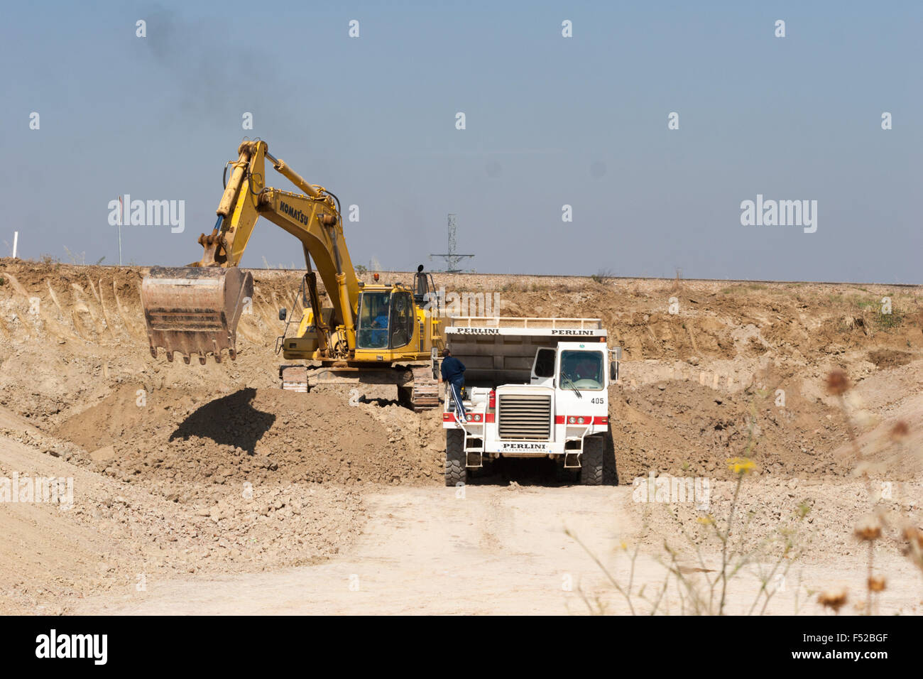 Mining truck and excavator in action Stock Photo - Alamy