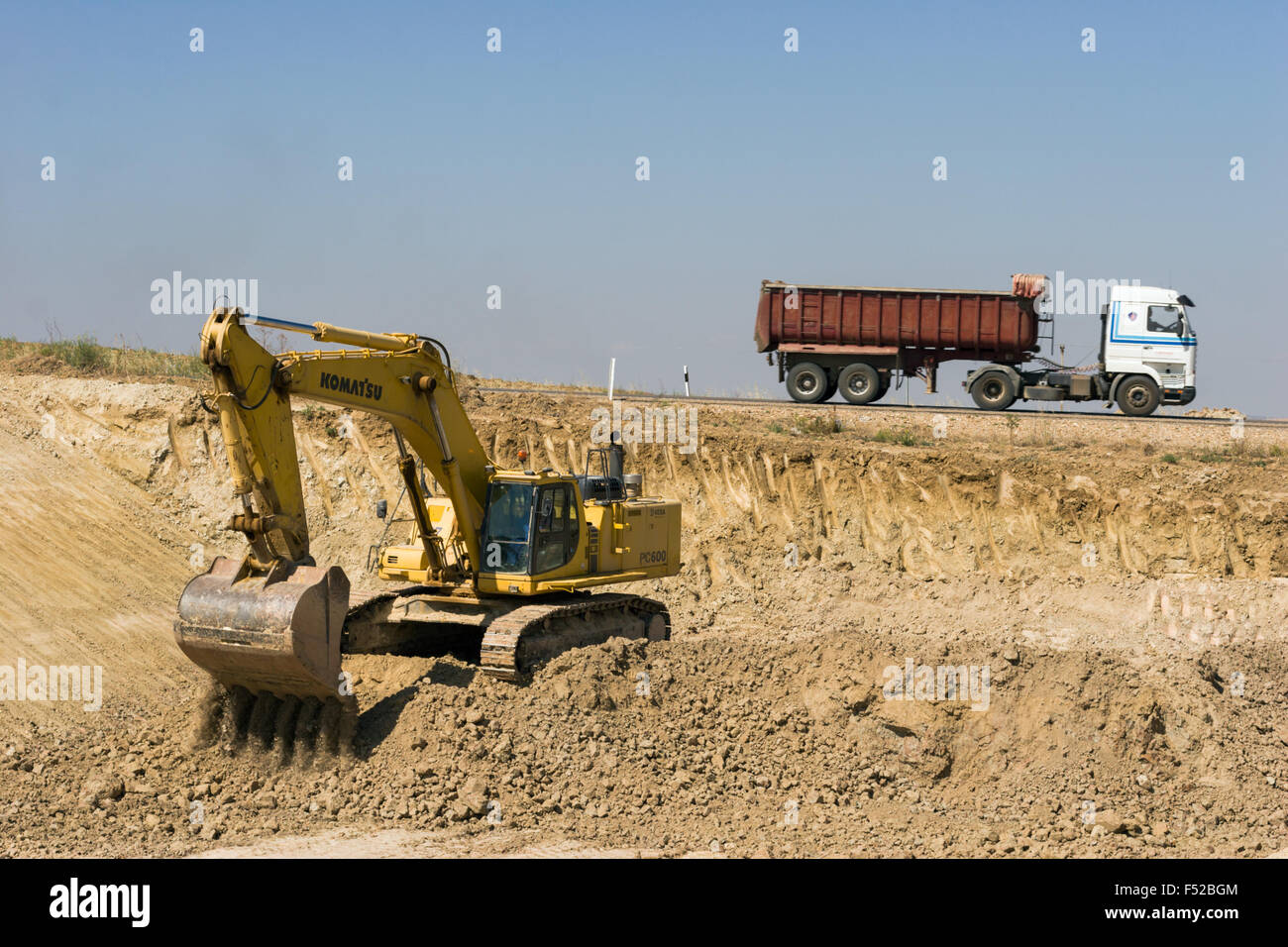 Excavator in action at work site Stock Photo - Alamy